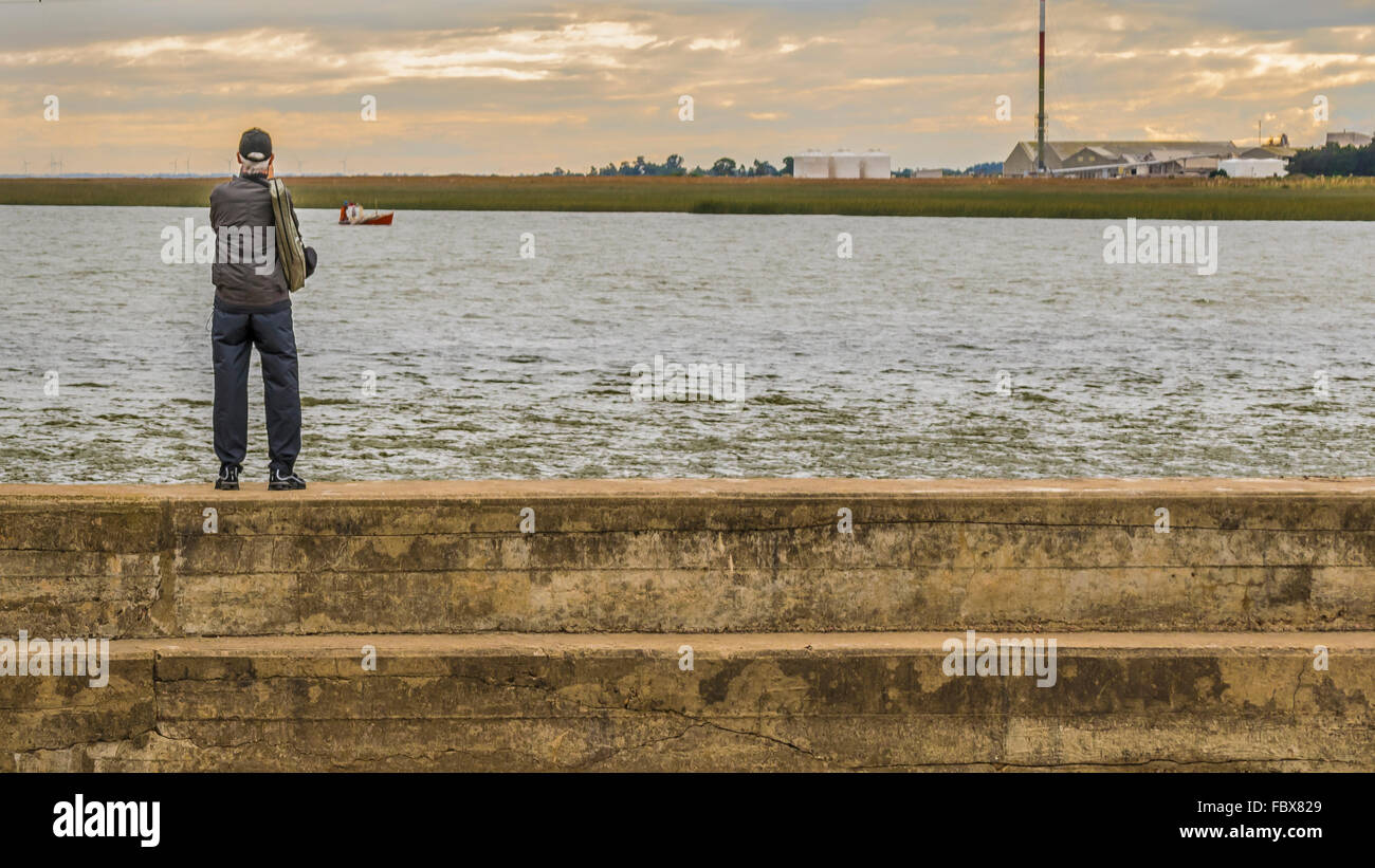 Back view of old tall caucasian man taking photos under the bridfe at ...