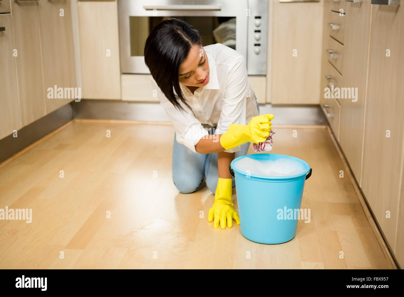 Attractive brunette cleaning the floor Stock Photo - Alamy