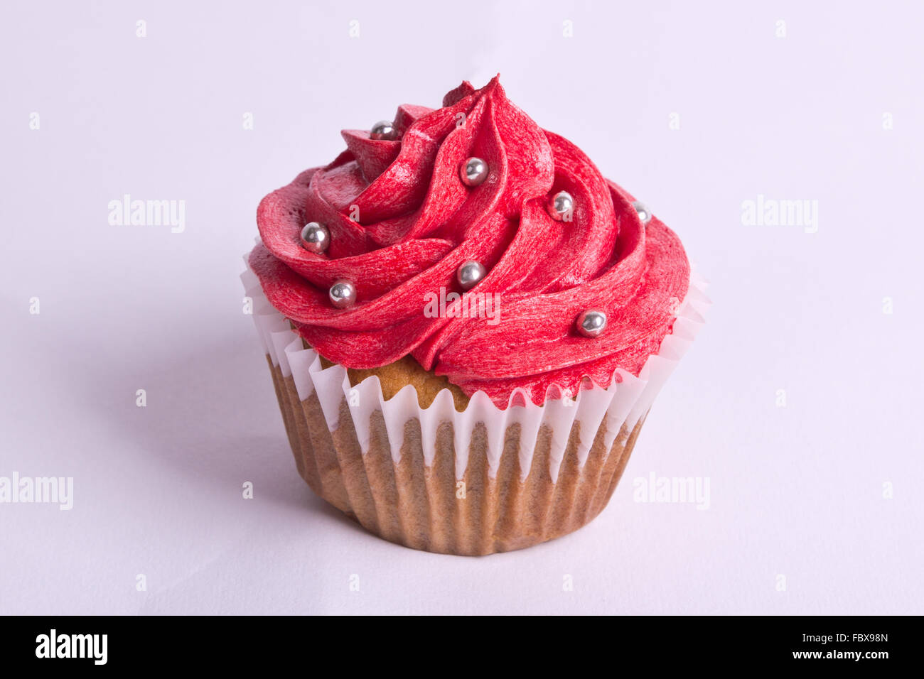Cupcake with red icing Stock Photo - Alamy