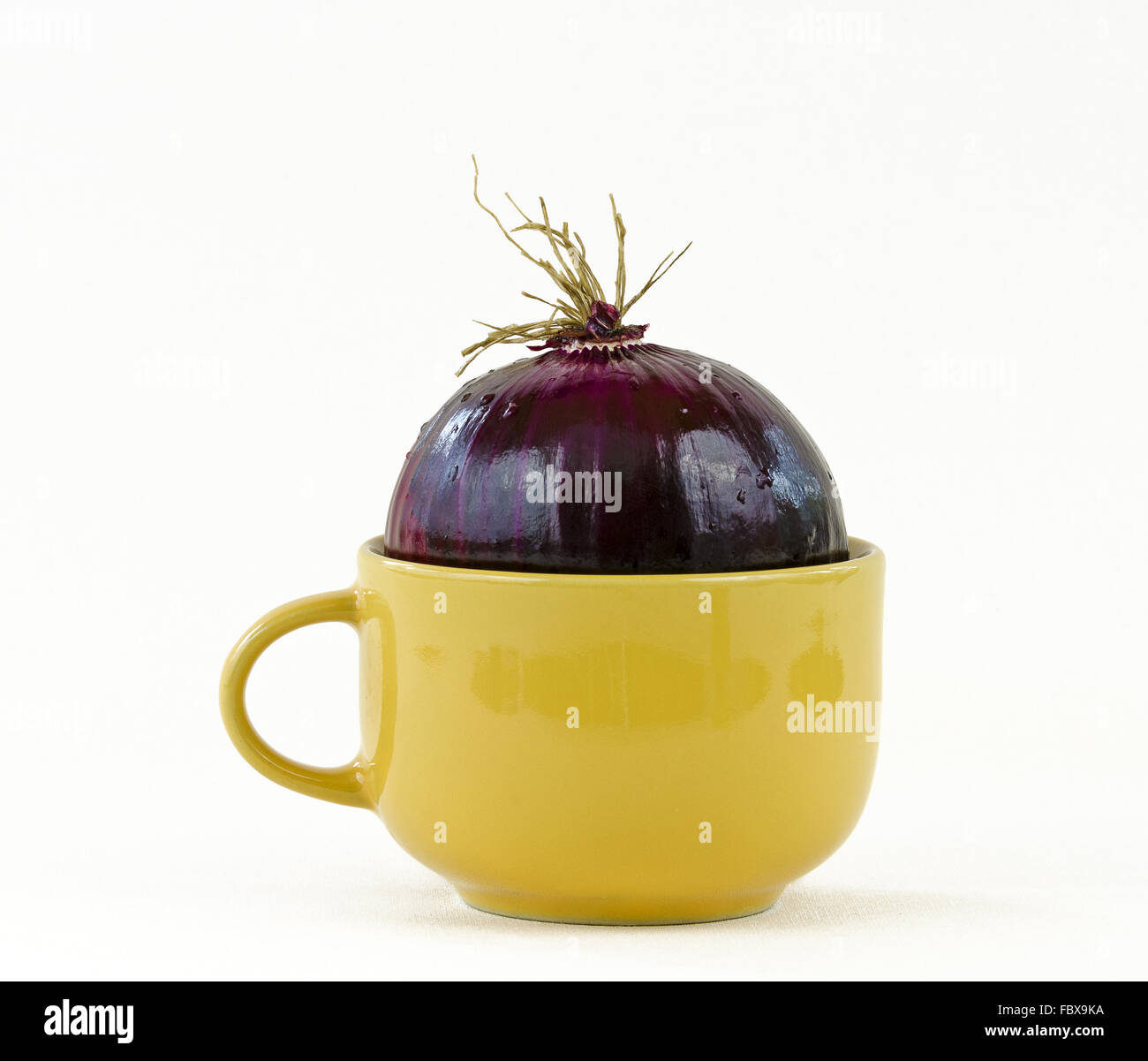 red onion in a yellow cup with handle Stock Photo - Alamy