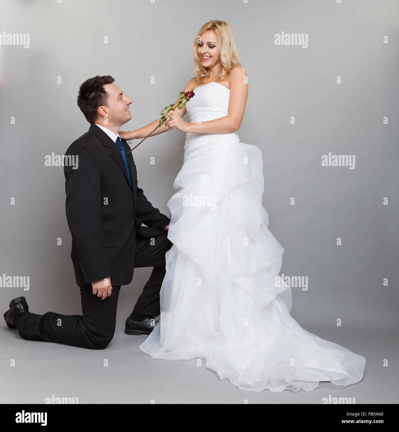 Romantic married couple bride and groom with rose Stock Photo - Alamy