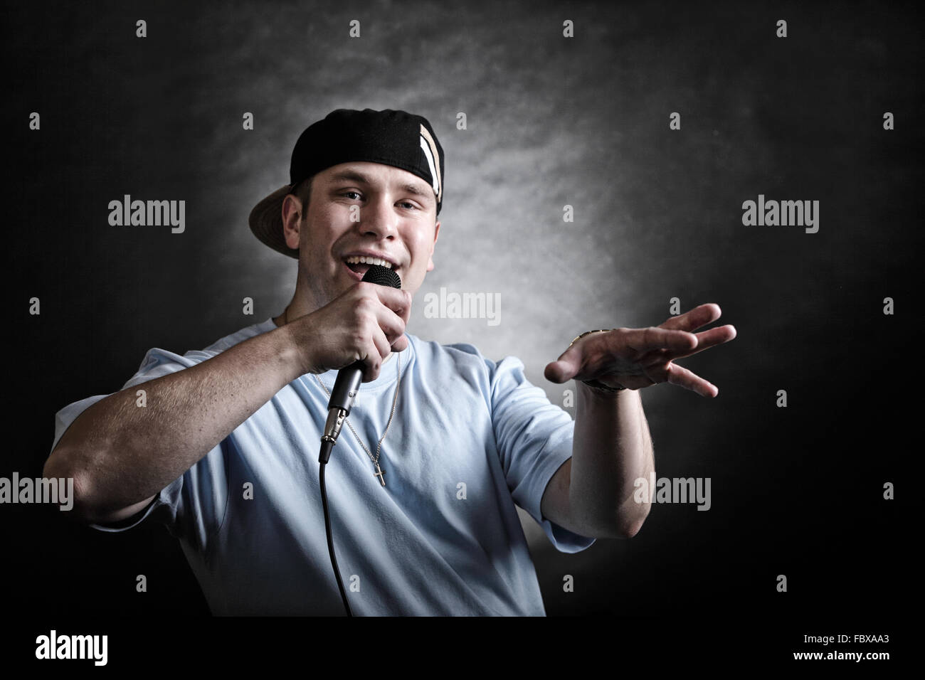 Rap singer man with microphone cool hand gesture Stock Photo - Alamy