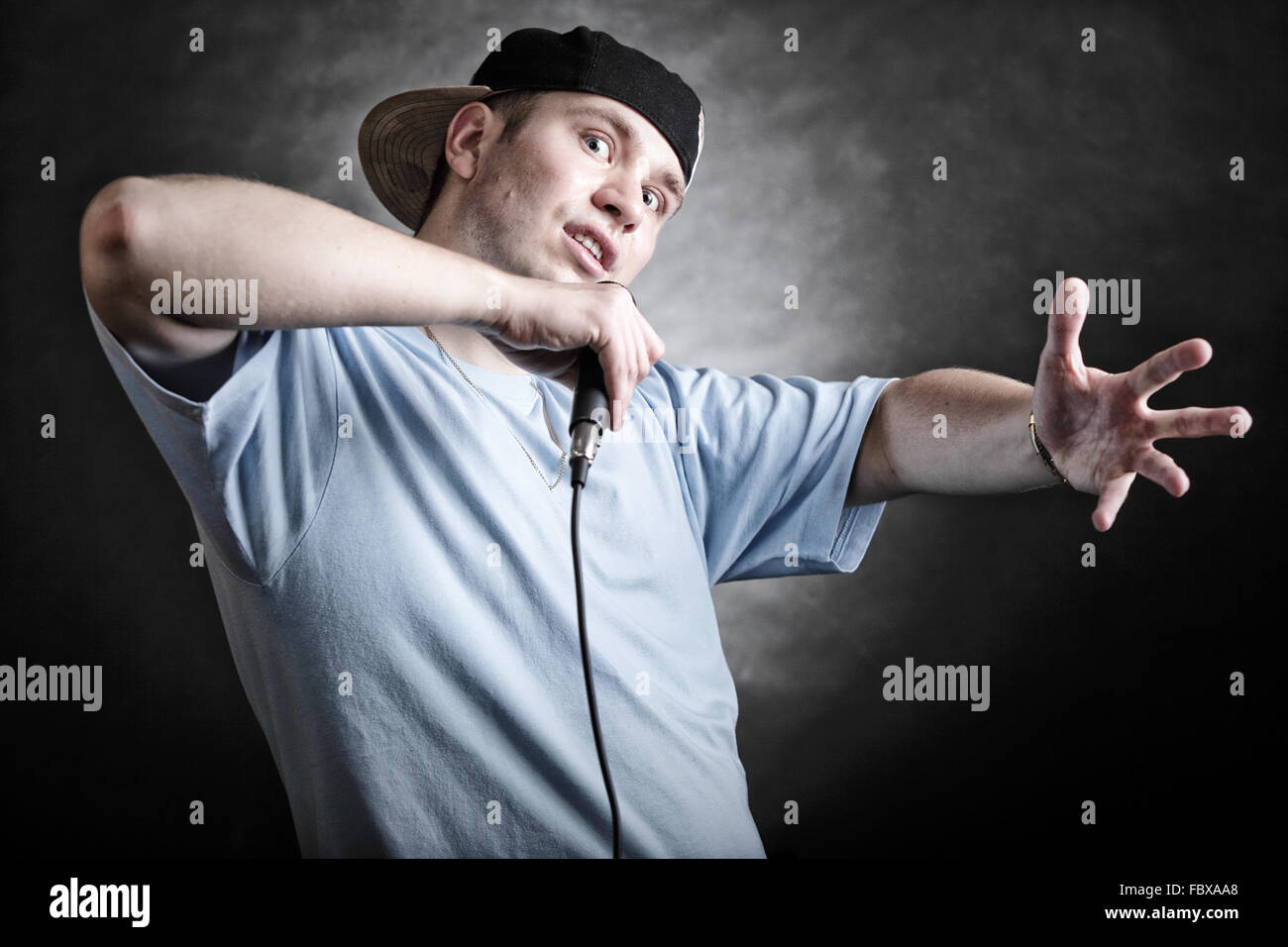 Rap singer man with microphone cool hand gesture Stock Photo - Alamy