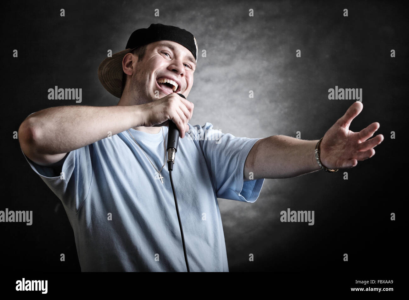 Rap singer man with microphone cool hand gesture Stock Photo - Alamy