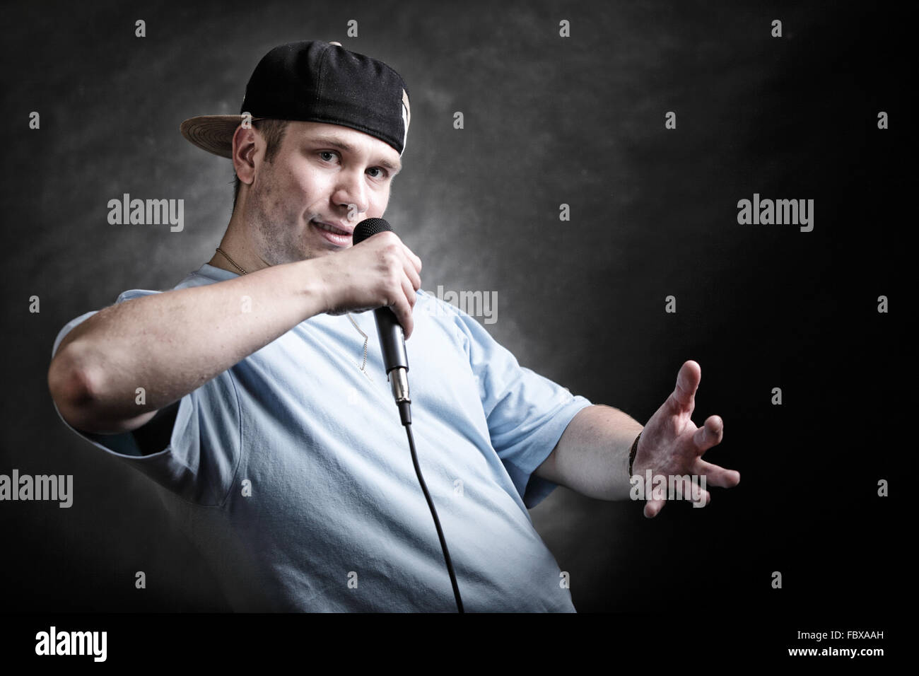 Rap singer man with microphone cool hand gesture Stock Photo - Alamy