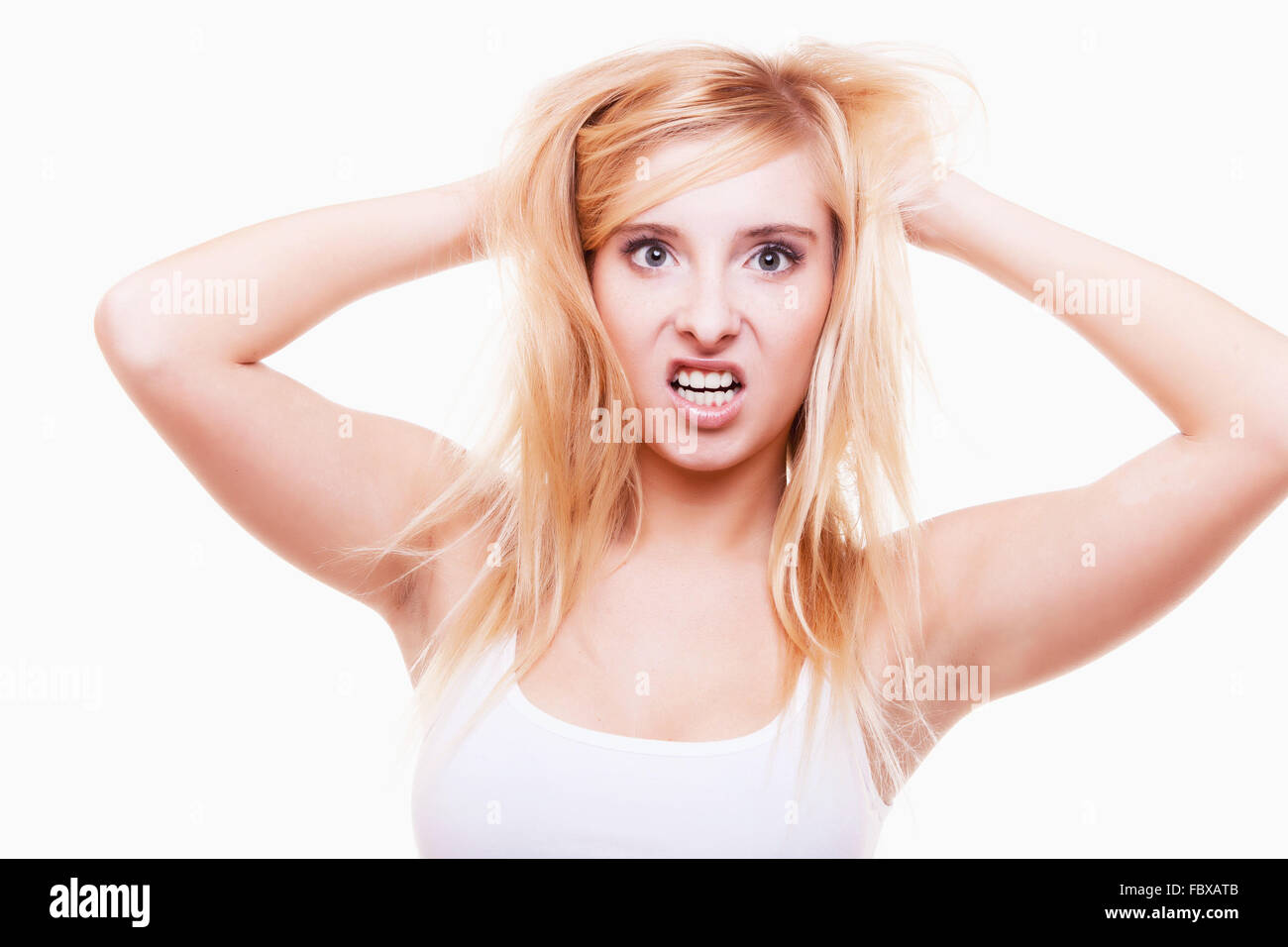 Stress. Young woman frustrated pulling her hair on white Stock Photo ...
