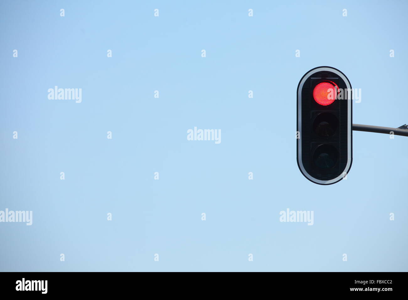 Red traffic lights against blue sky backgrounds Stock Photo - Alamy