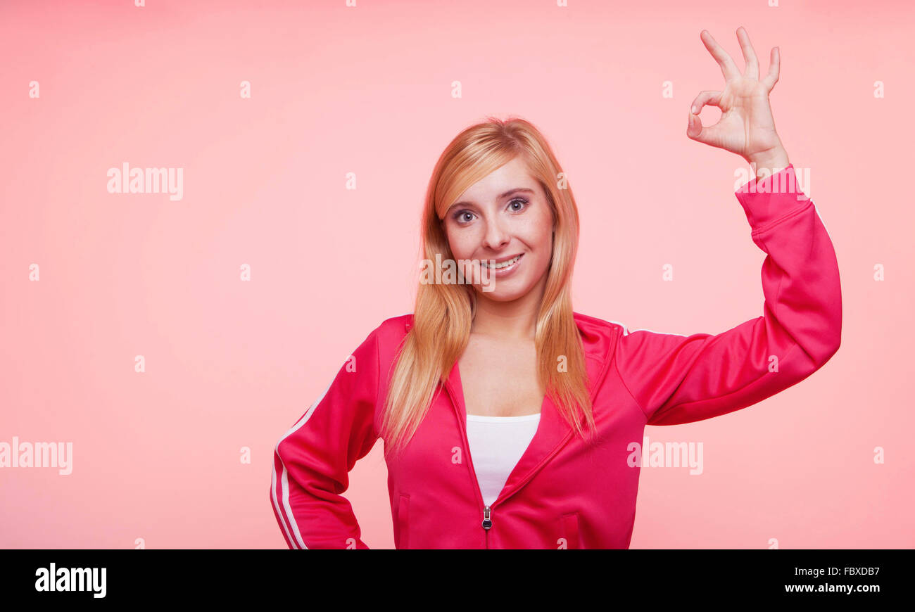 sporty fit woman showing ok sign hand gesture Stock Photo - Alamy