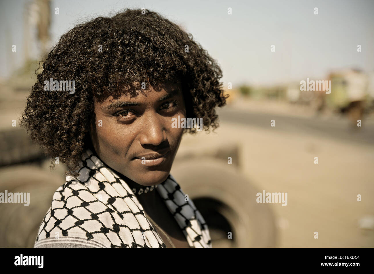 Portrait of a young Afar man with curly hair in Mille, Afar Region ...