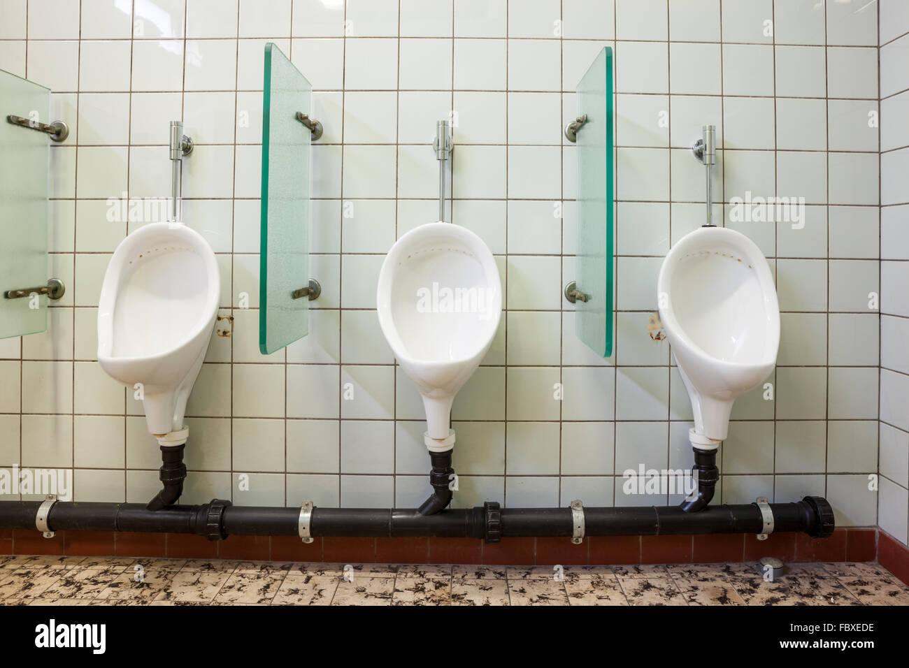 urinals in an old building for men only Stock Photo - Alamy