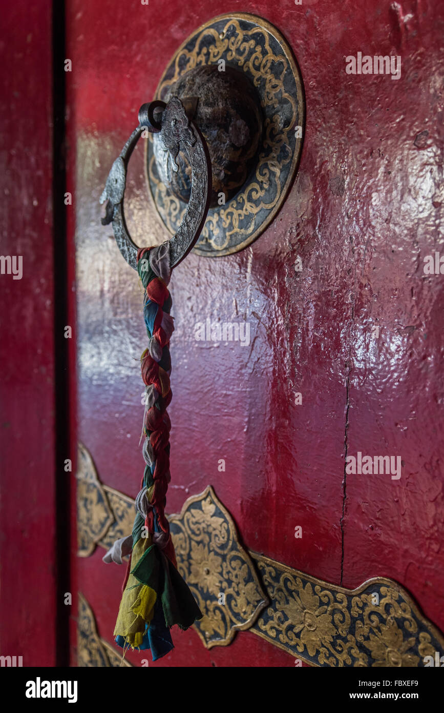 Ornate door handle with plaited colourful cloth decoration at the small ...