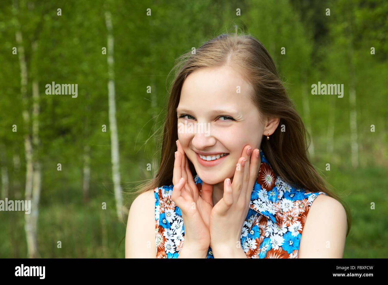 The smiling girl among trees Stock Photo - Alamy