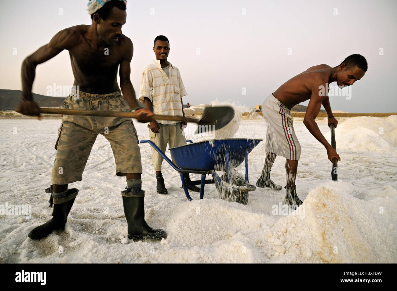 African workers in a salt pans on the shore of Lake Afrera, Afar Region ...