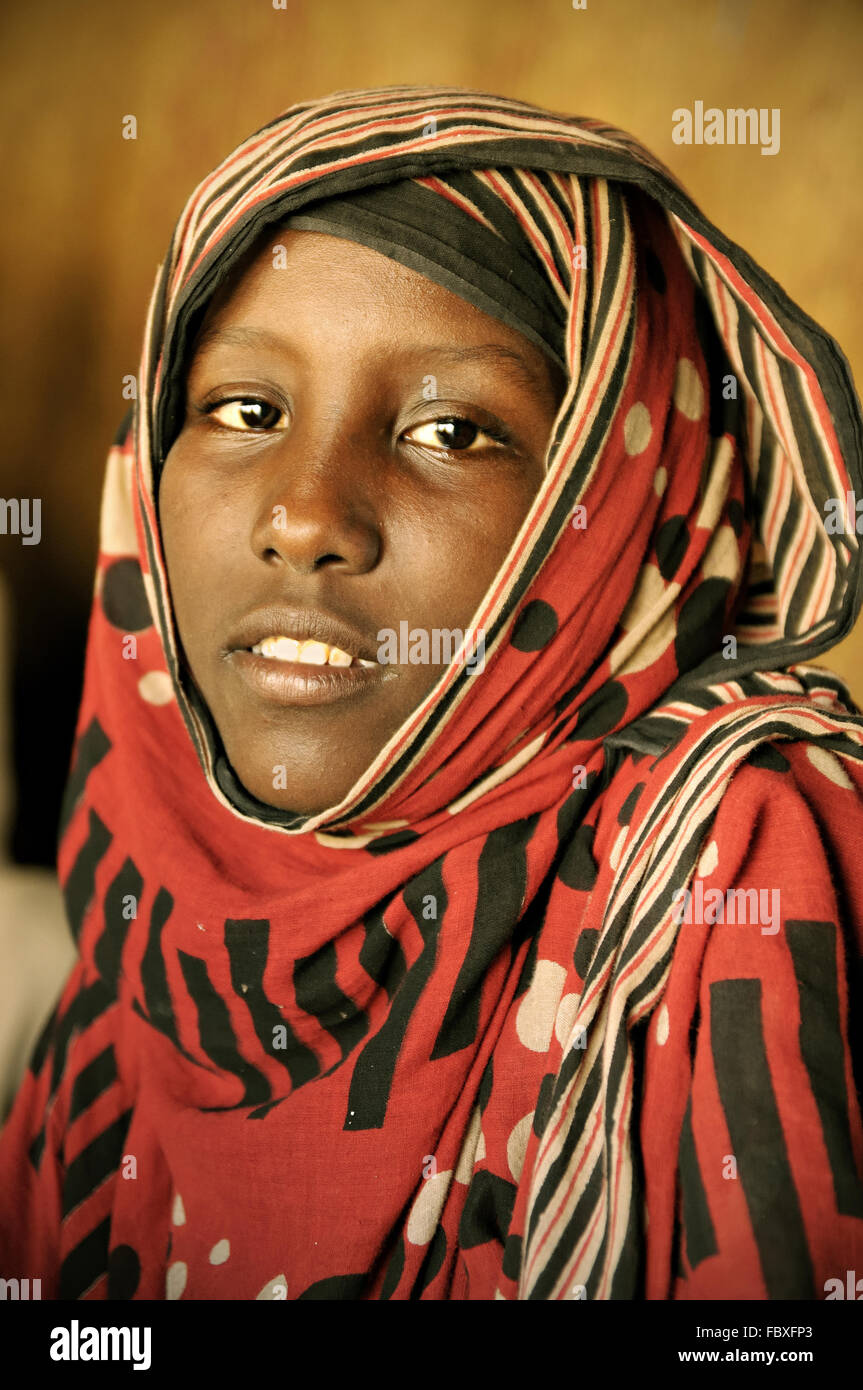 Young muslim woman wearing a red hijab inside her house in Dodom ...