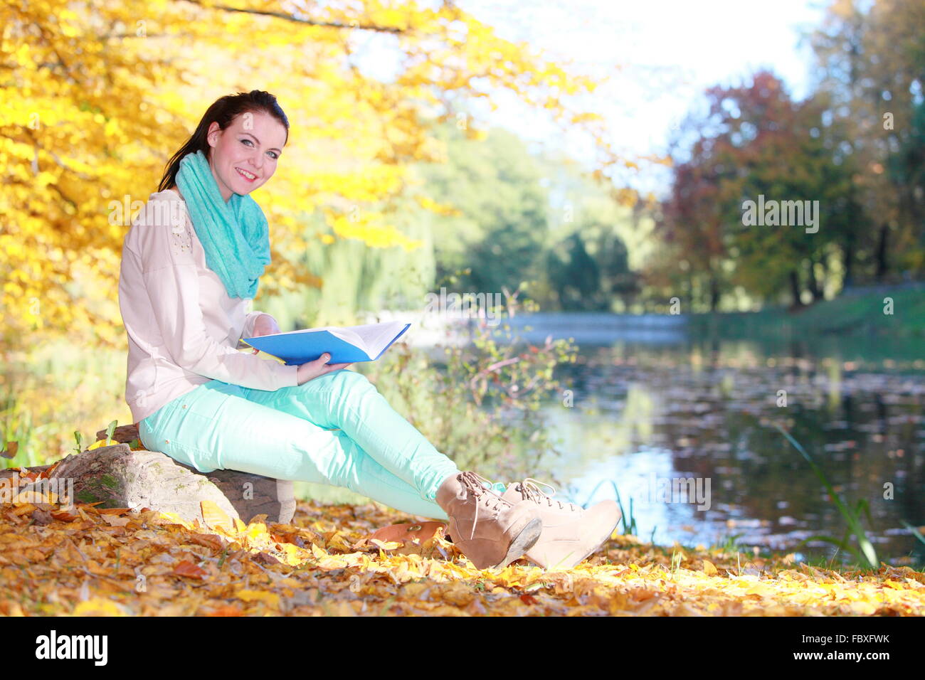 Woman happy reading outside hi-res stock photography and images - Alamy