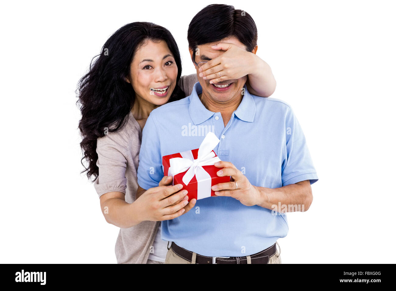 Smiling woman giving her partner a present Stock Photo - Alamy
