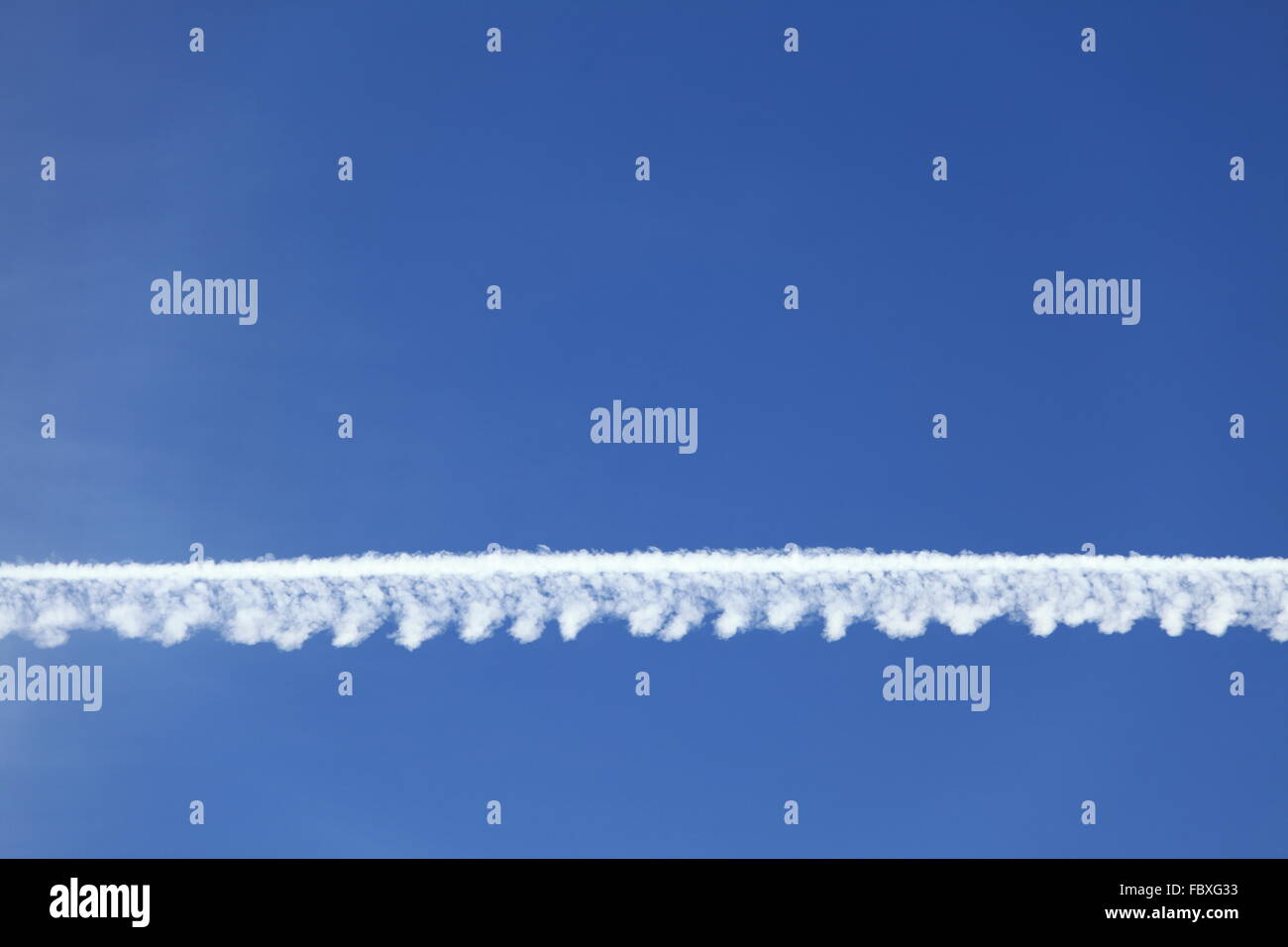 Airplane tracks in the blue sky Stock Photo - Alamy