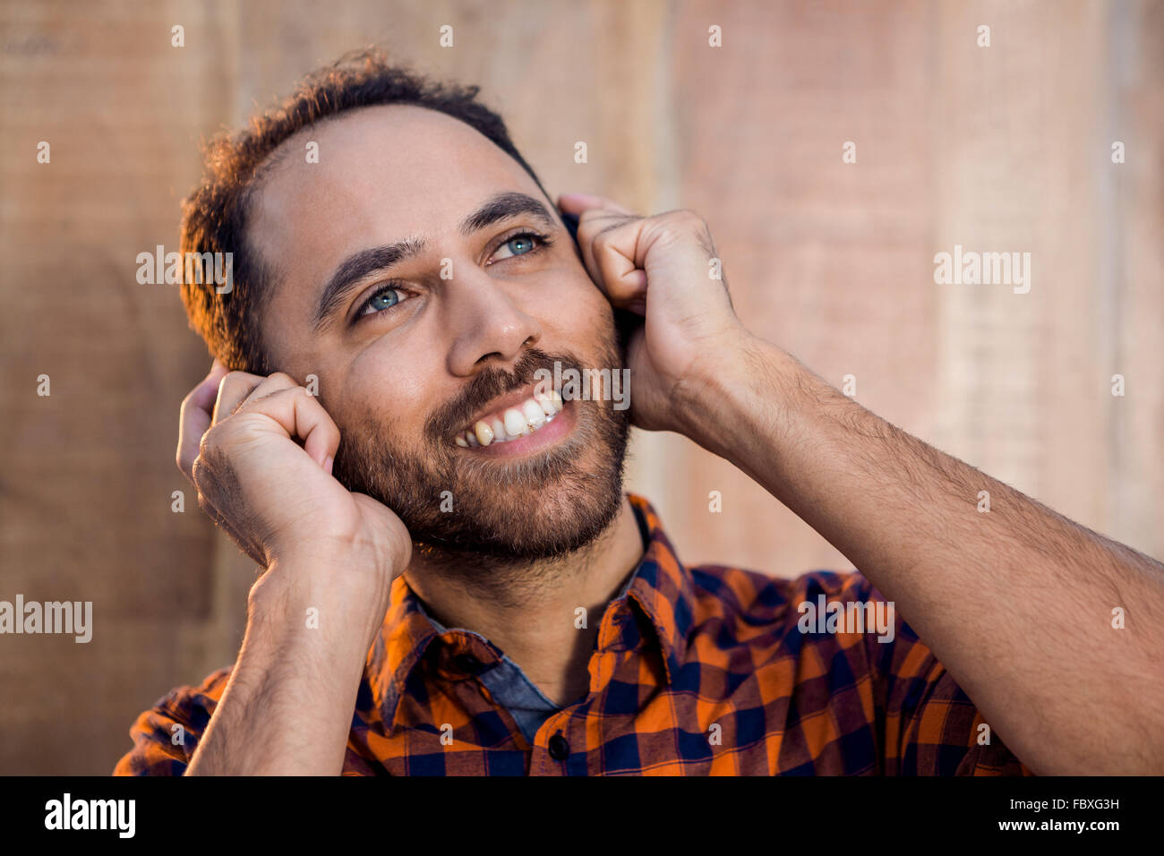 Happy man looking up while standing in office Stock Photo - Alamy