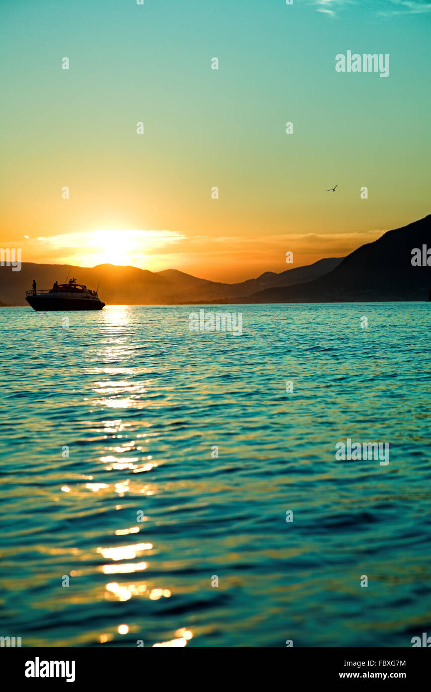 Sunset with boat Stock Photo - Alamy