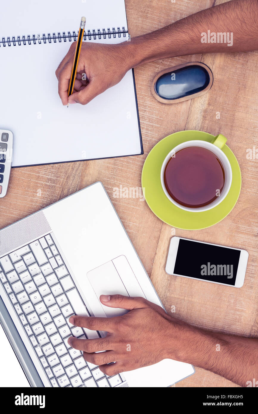 Overhead view of businessman working on laptop Stock Photo - Alamy