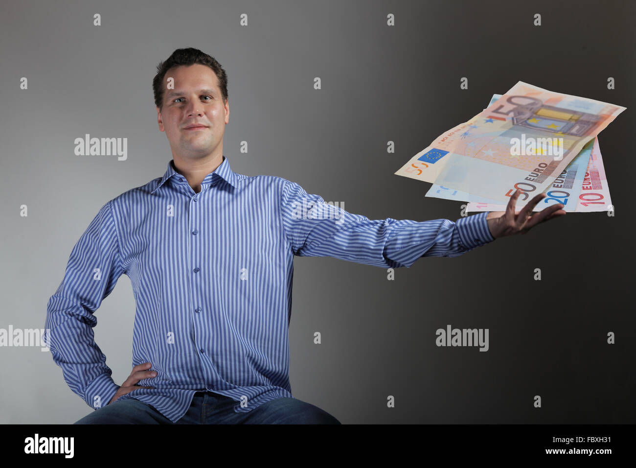 Man euro banknote in hand. Finance and economy Stock Photo - Alamy