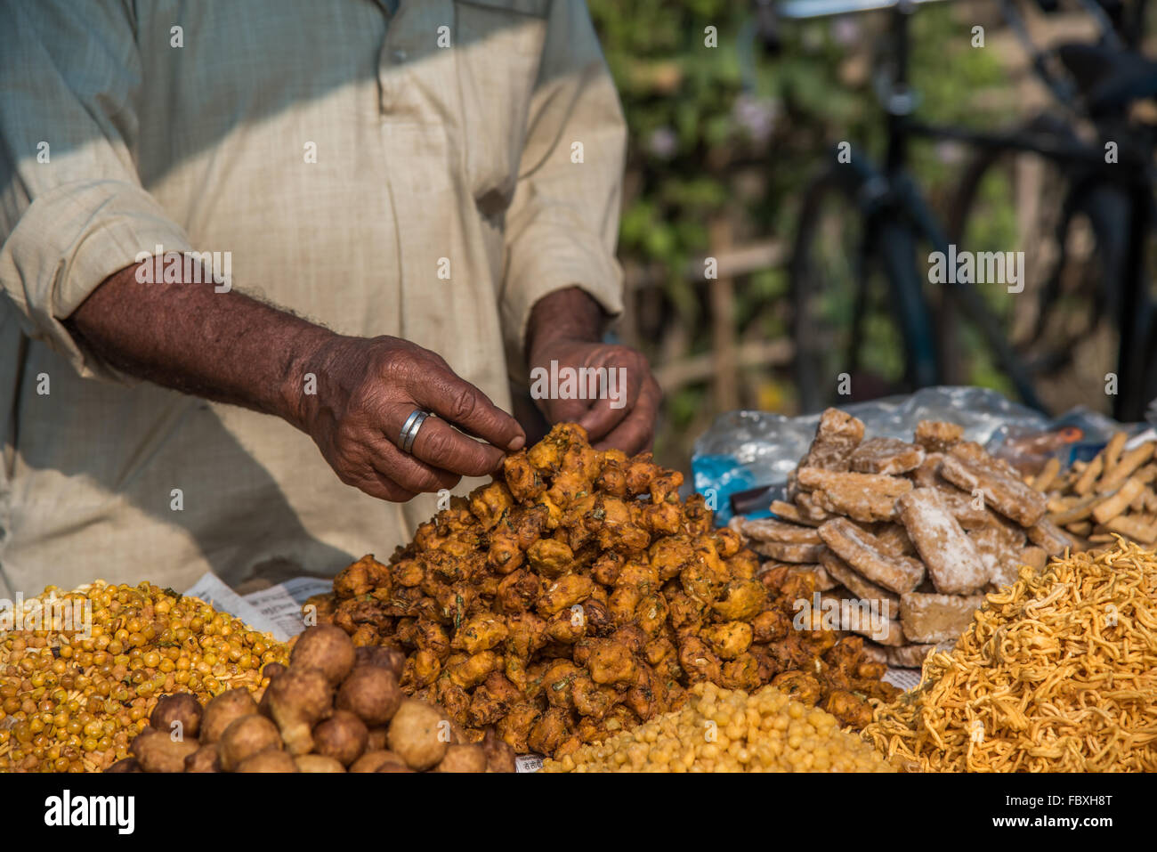 Indian market. A selection of vibrant yellow snacks available at the ...