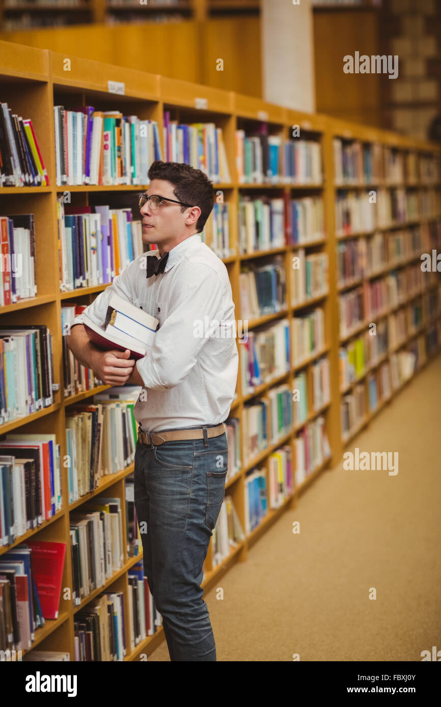Portrait of nerd holding books Stock Photo - Alamy
