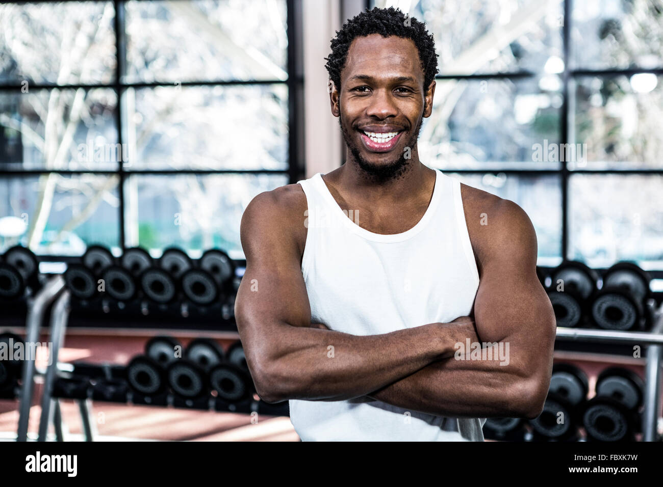 Muscular man posing with crossed arms Stock Photo - Alamy