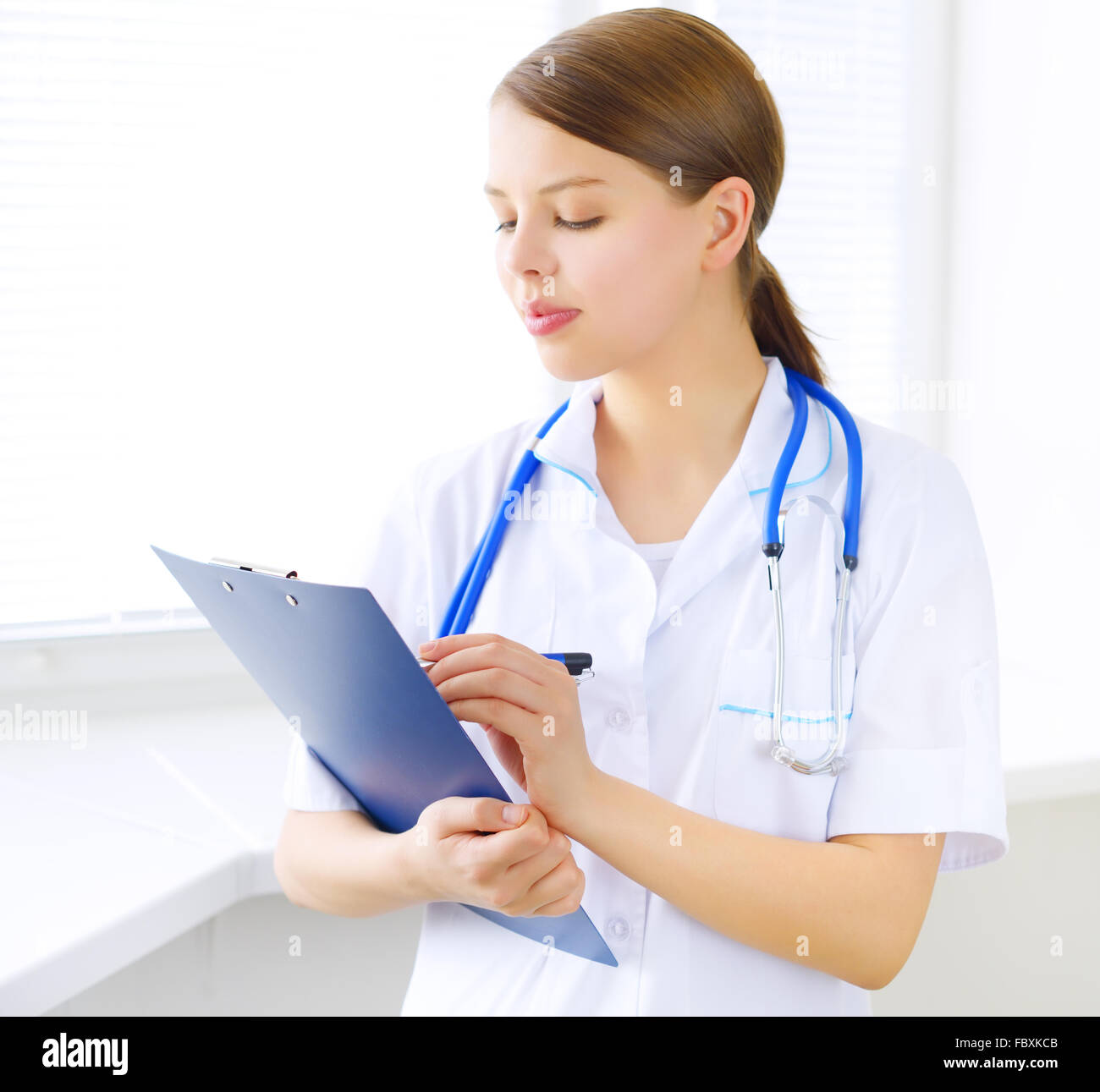 Female doctor with notepad Stock Photo - Alamy