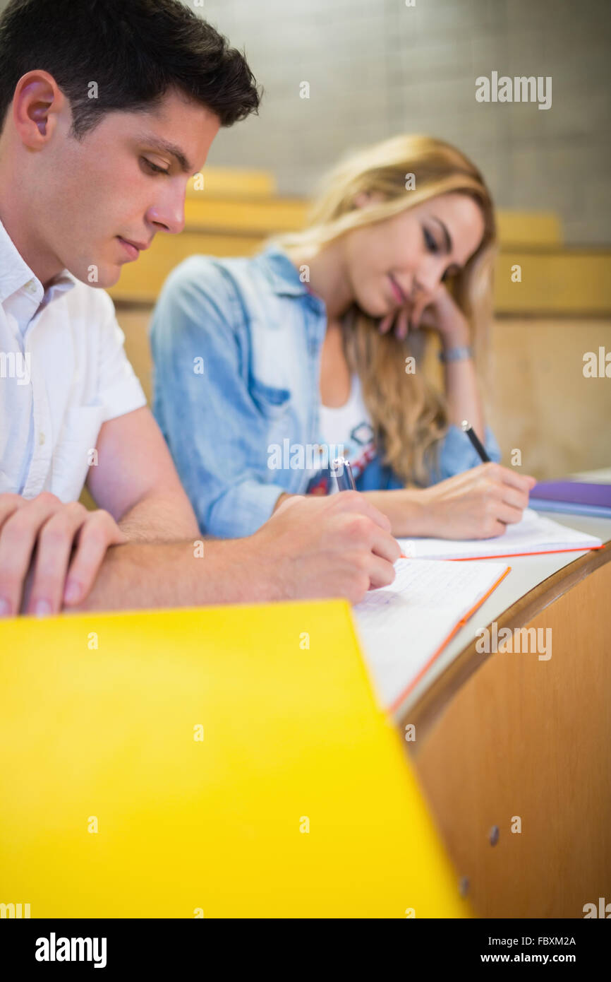 Serious students writing during class Stock Photo - Alamy