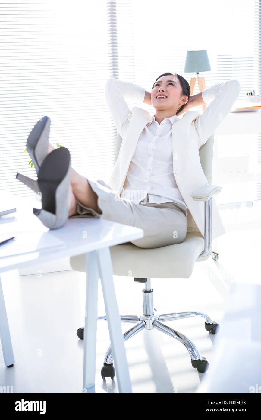 Businesswoman relaxing legs on desk hi-res stock photography and images ...