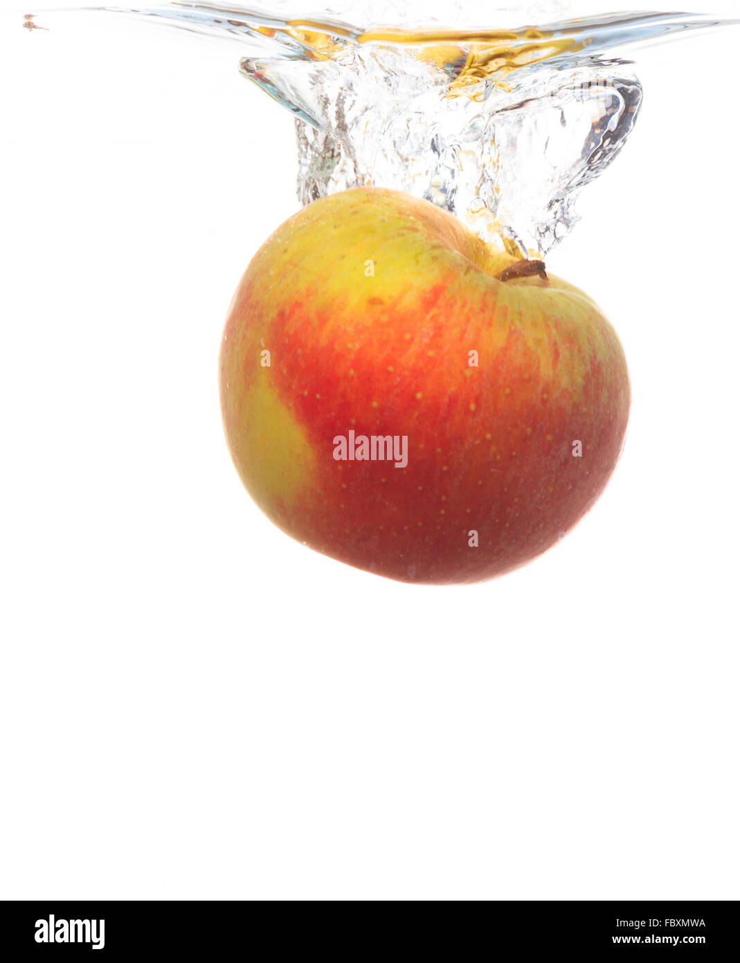 Yellow apple in the water splash over white Stock Photo - Alamy