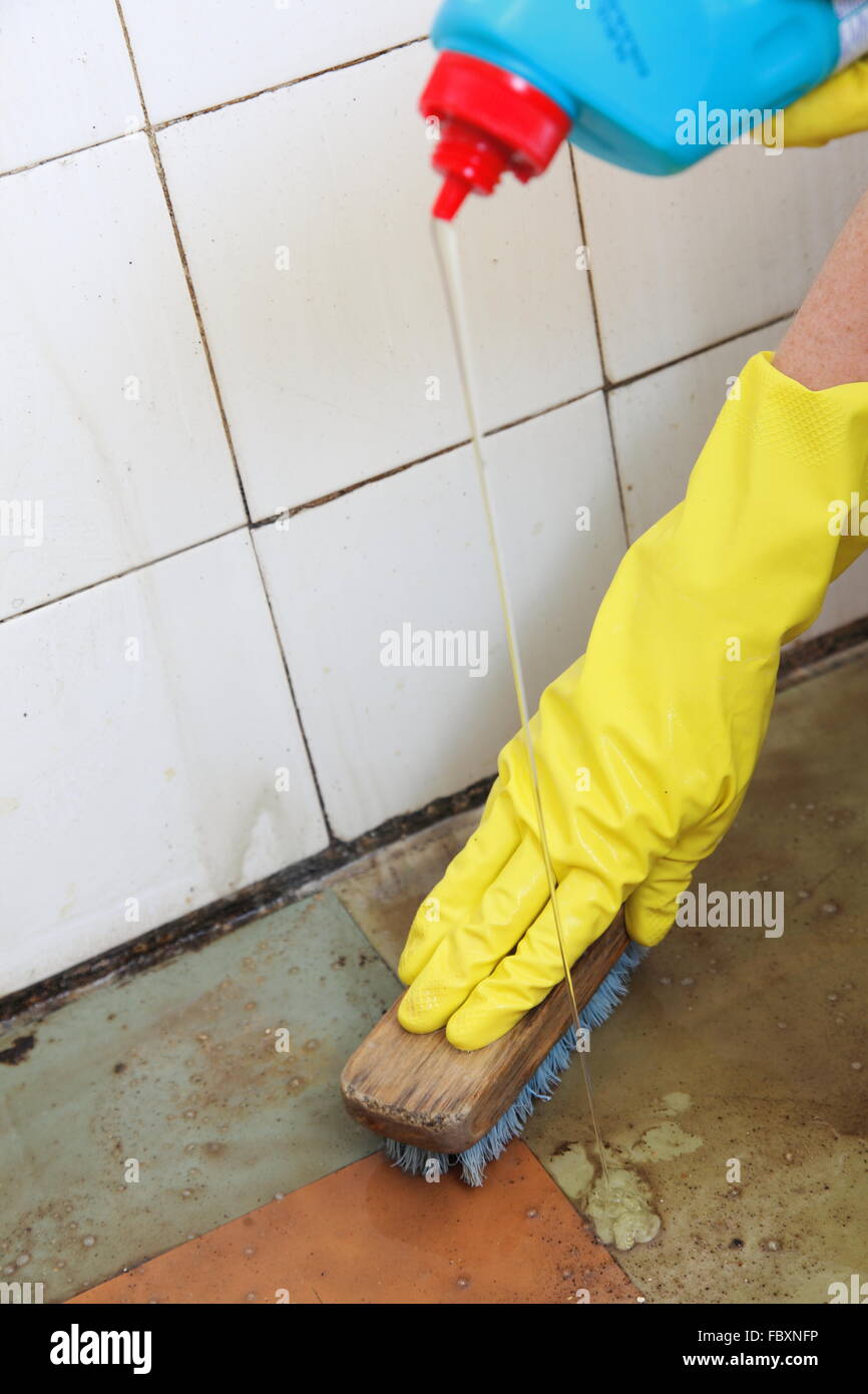 gloved hand cleaning of dirty filthy floor Stock Photo - Alamy