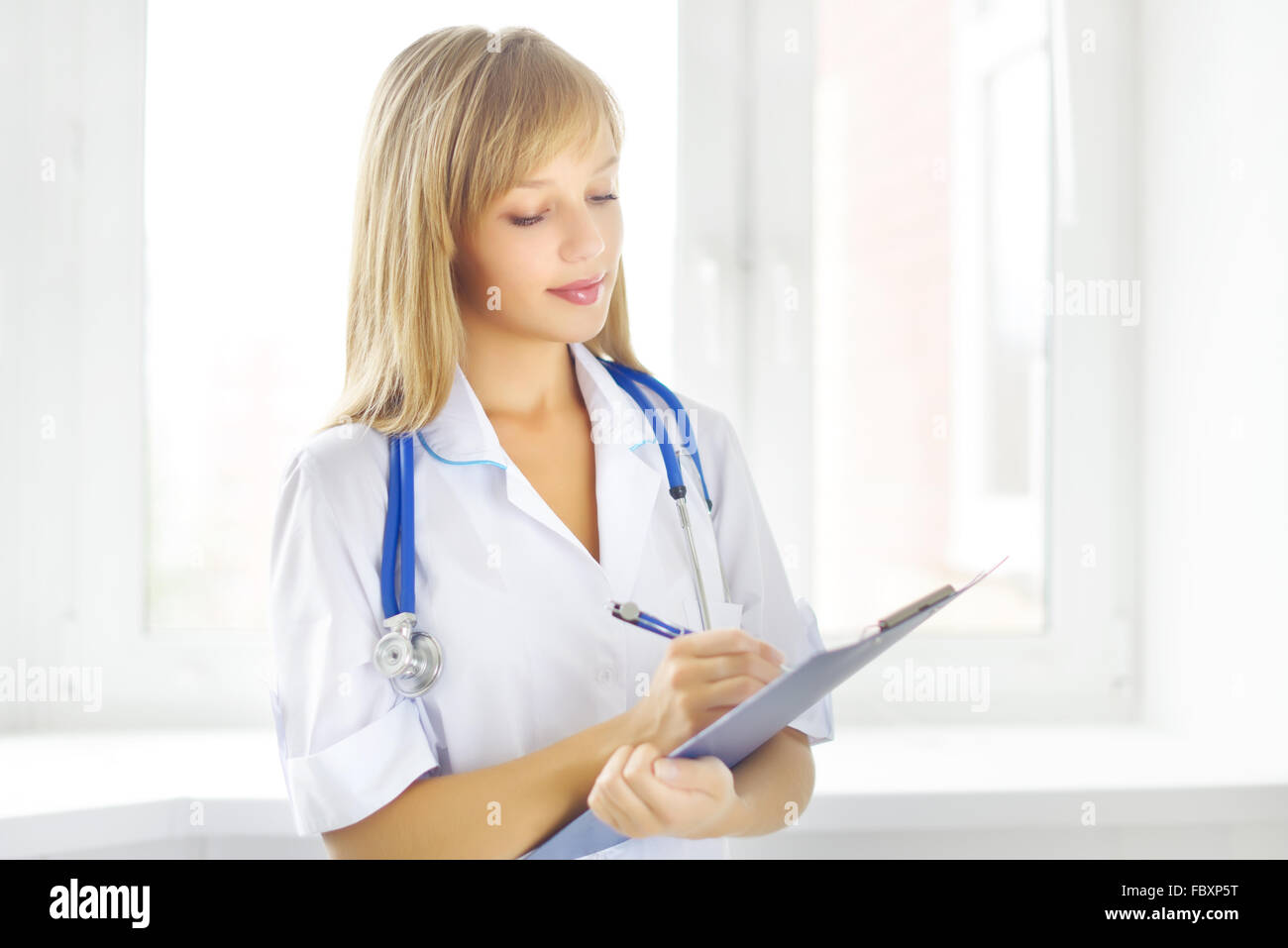 female doctor holding a notepad Stock Photo - Alamy