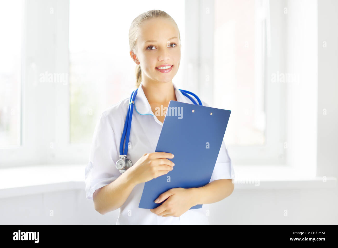 female doctor holding a notepad Stock Photo - Alamy