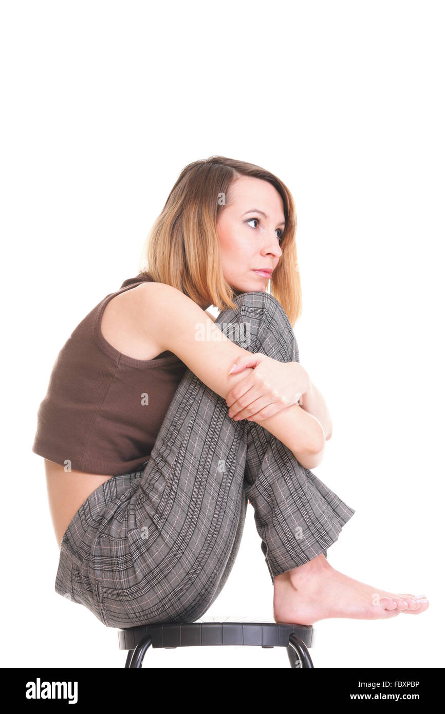 worried and afraid young woman sitting on chair. Isolated on white ...