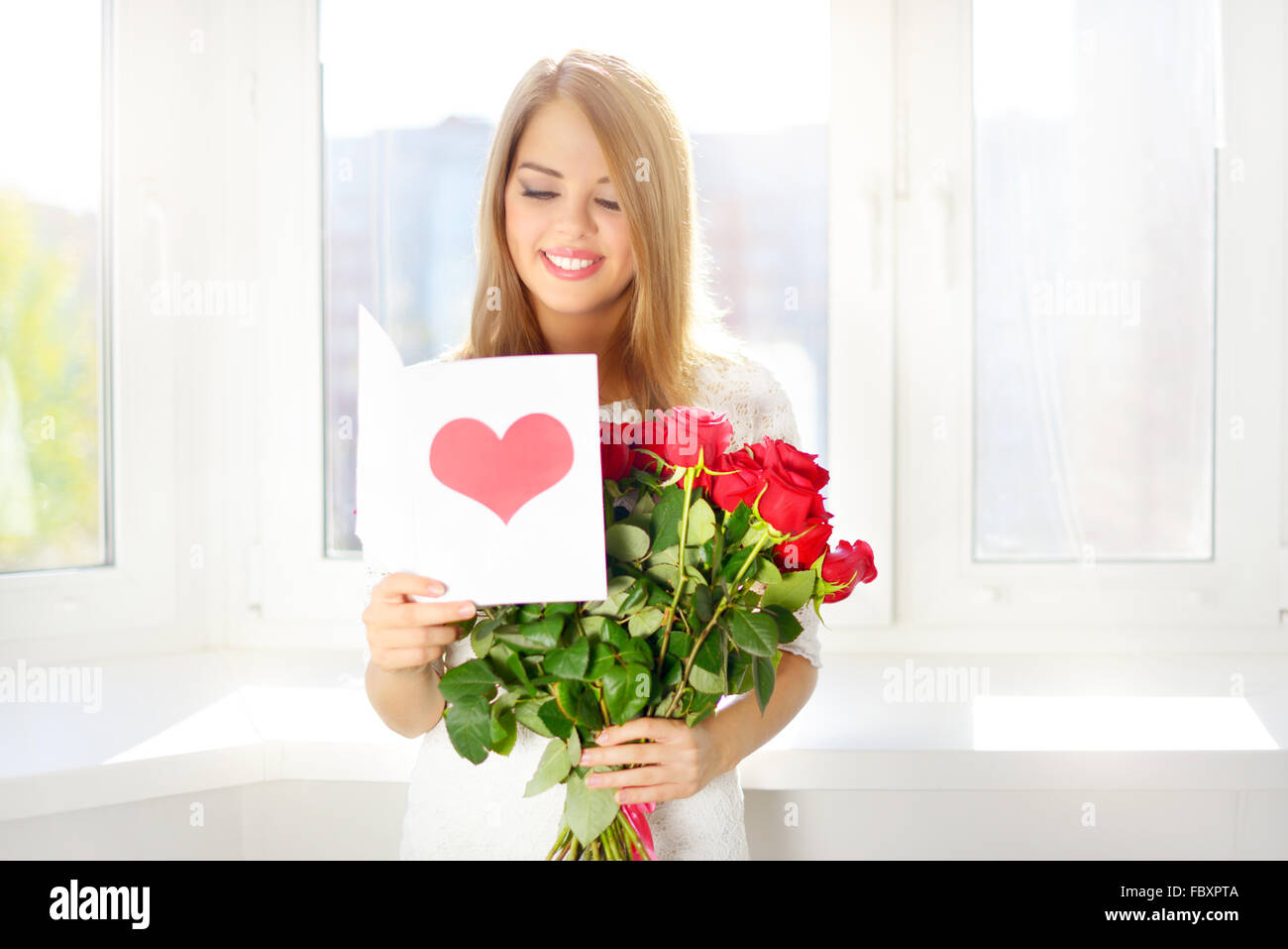 beautiful girl with bouquet of red roses Stock Photo - Alamy
