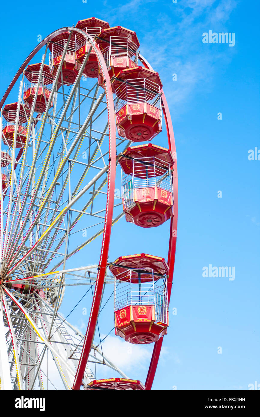 Red Ferris Wheel against blue sky at amusement park Stock Photo - Alamy