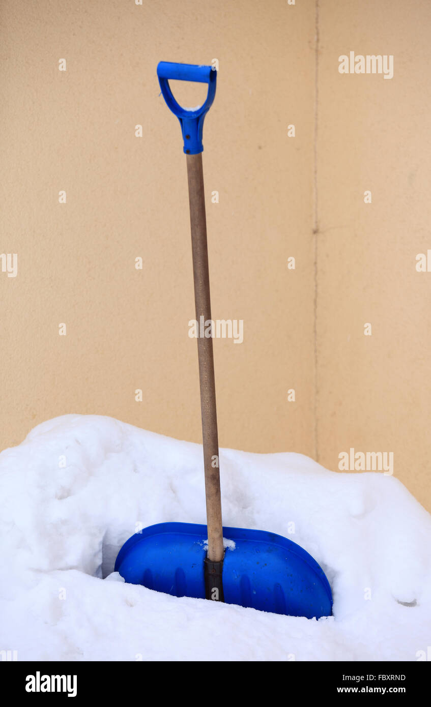blue snow shovel standing up in deep snow Stock Photo - Alamy