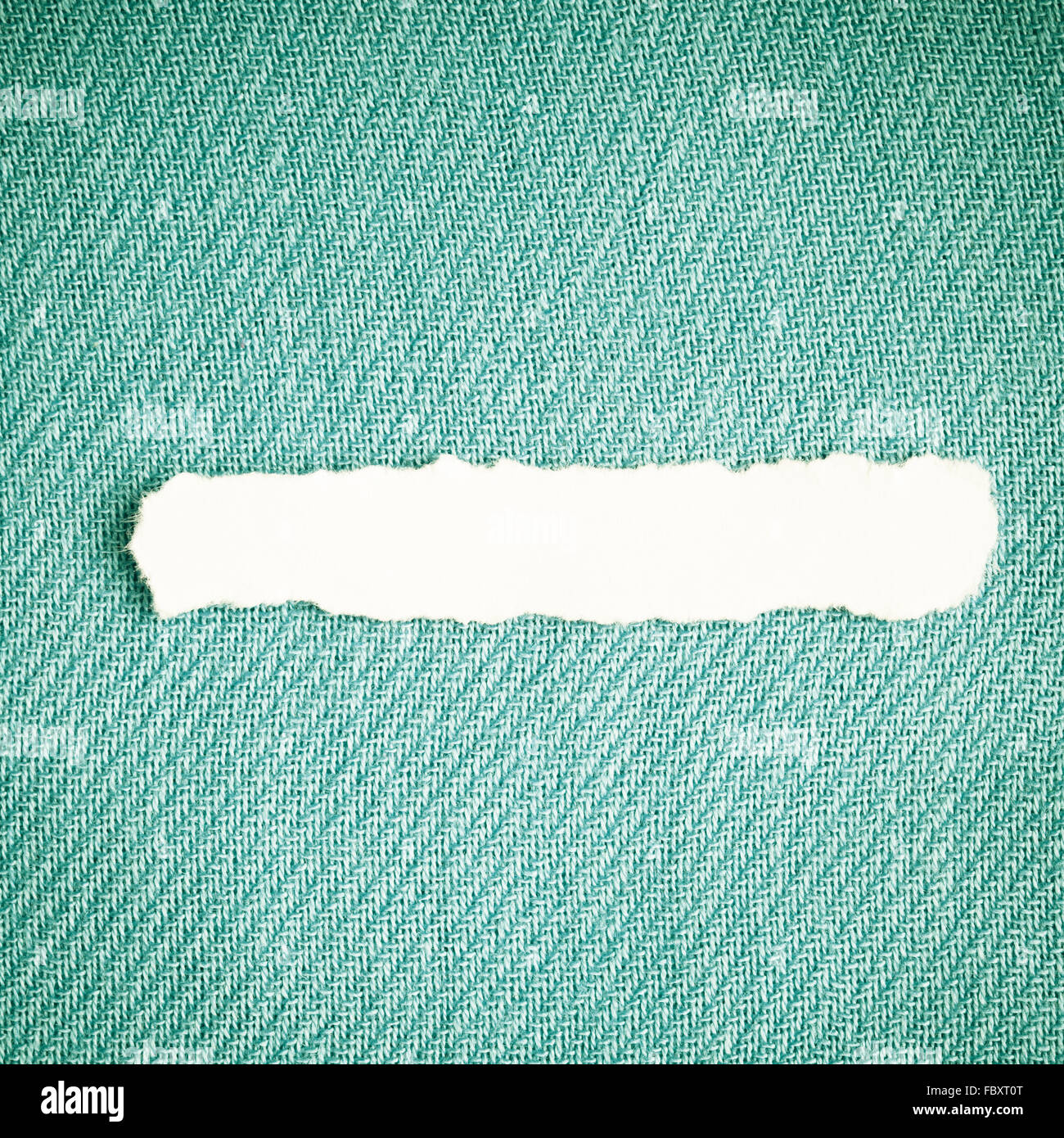 Piece scrap paper blank copy space on green fabric textile material ...