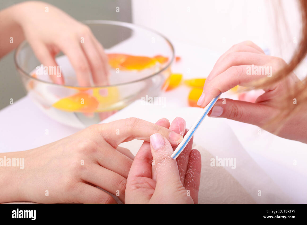Beautician With File Filing Nails Female Client Woman Spa Beauty Salon