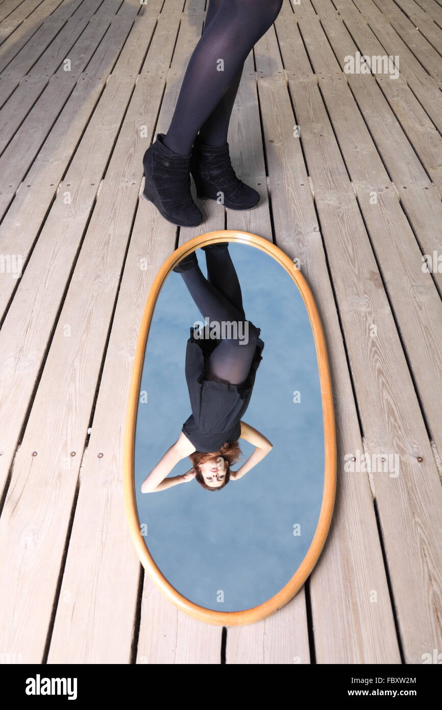 thoughtful woman with her reflection in mirror Stock Photo - Alamy