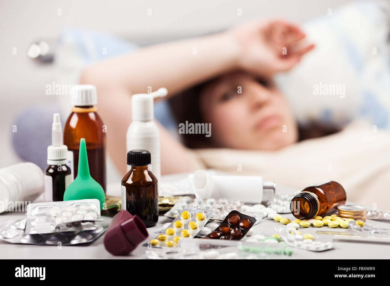 Unwell woman patient lying down bed Stock Photo - Alamy