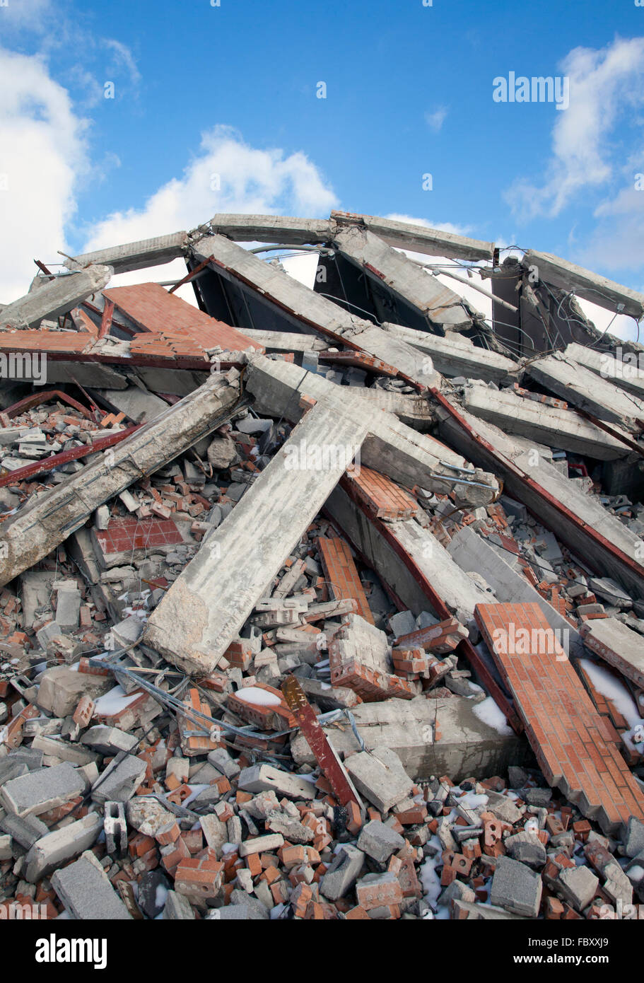Rubble pile of wrecked building, blue sky and clouds, 2015 Stock Photo ...