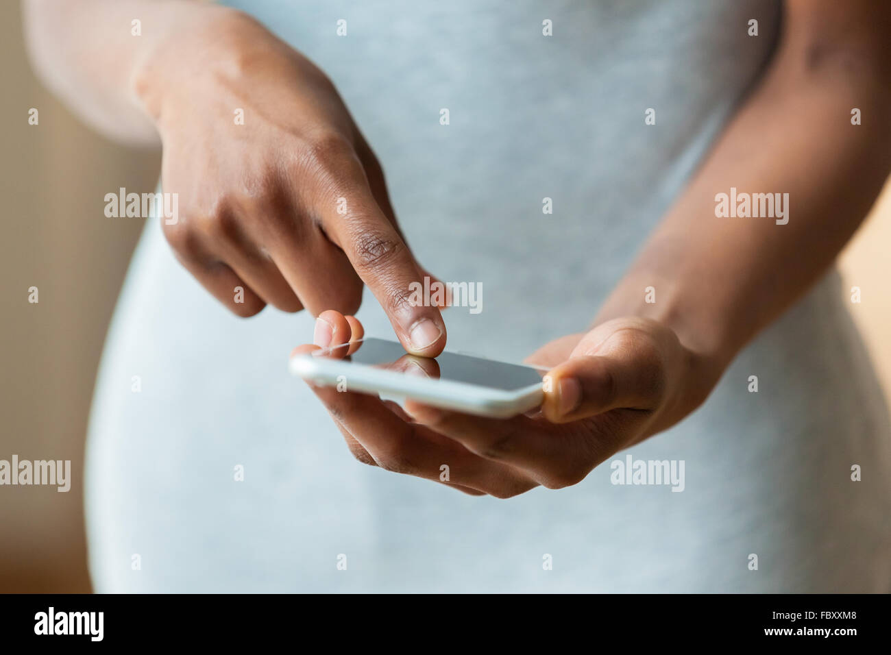 African american person holding a tactile mobile smartphone - Black ...