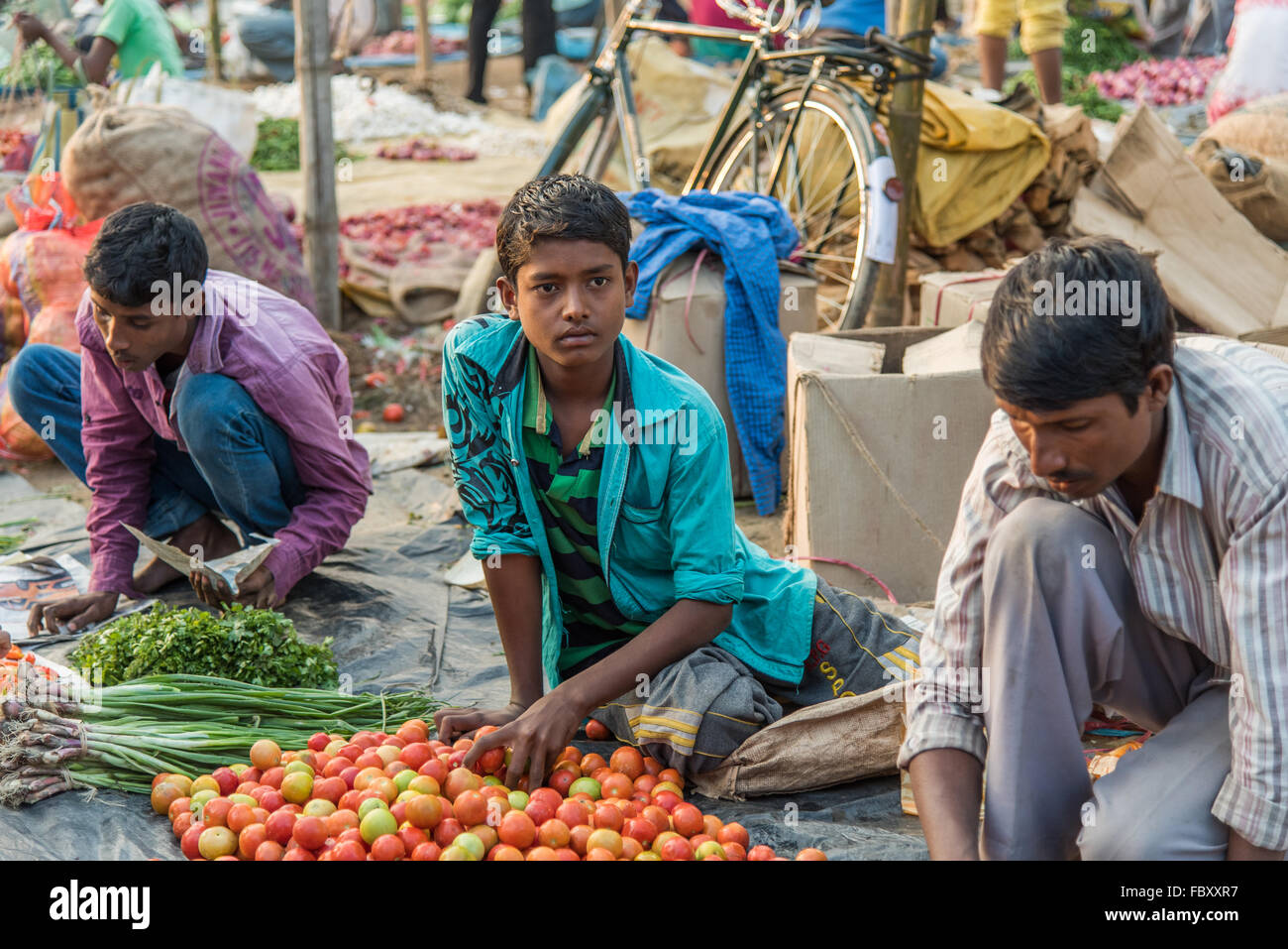 Indian market. Three male market traders selling fresh fruit and ...
