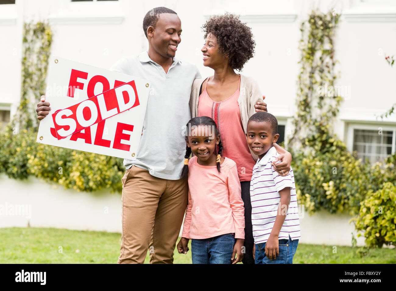 Happy family standing together Stock Photo - Alamy