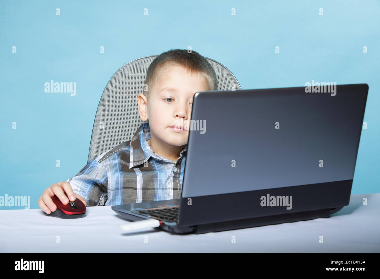 Computer addiction child with laptop notebook Stock Photo - Alamy