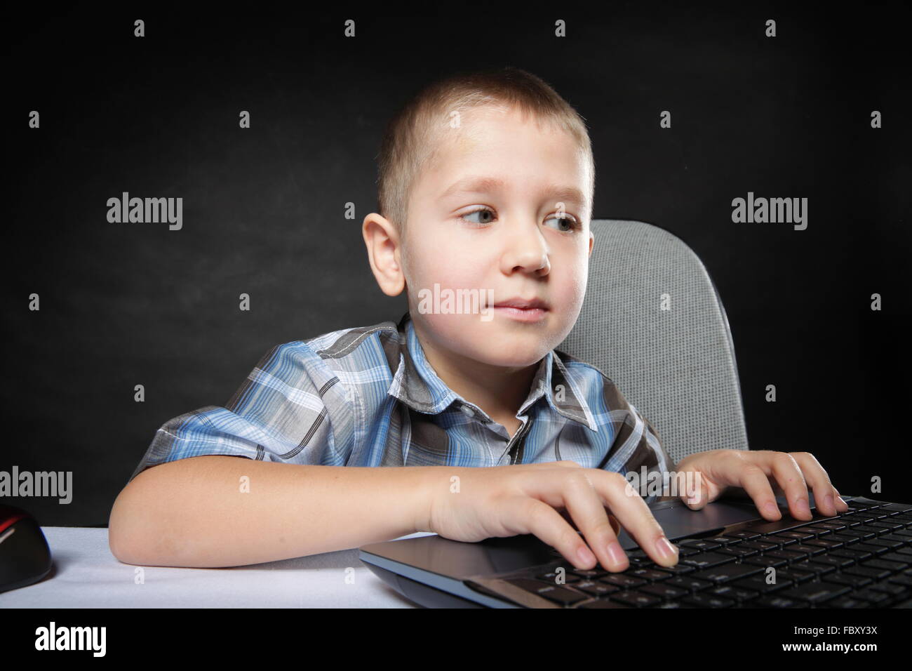Computer addiction child with laptop notebook Stock Photo - Alamy