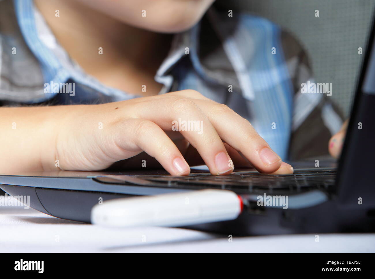 boy's hand typing on laptop keyboard Stock Photo - Alamy
